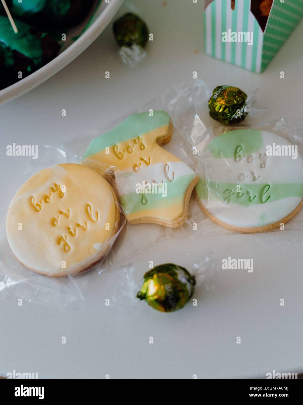 A vertical close-up shot of "boy or girl" cookies for a gender reveal ...