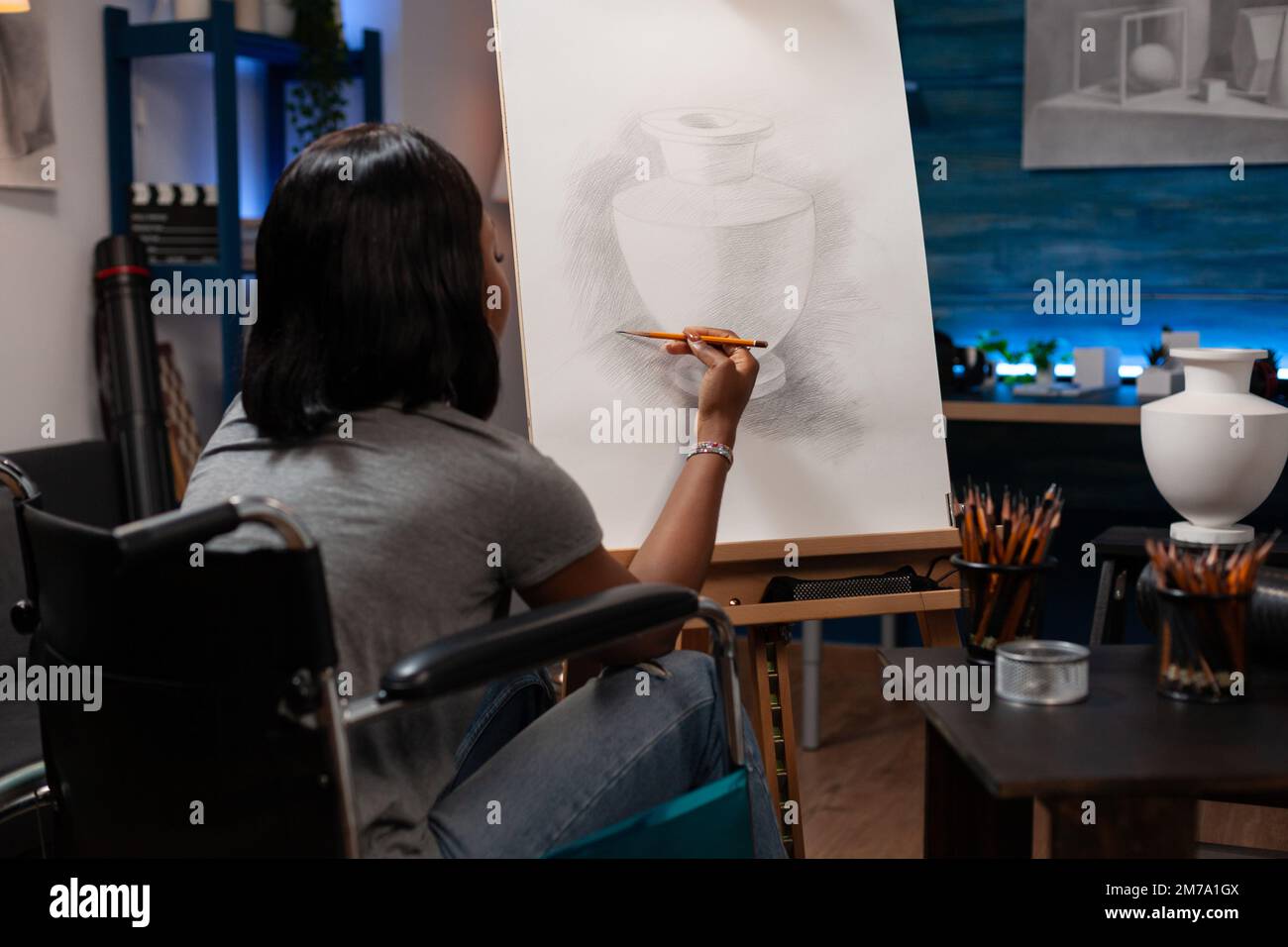 African american female professional artist using wheelchair to get ...