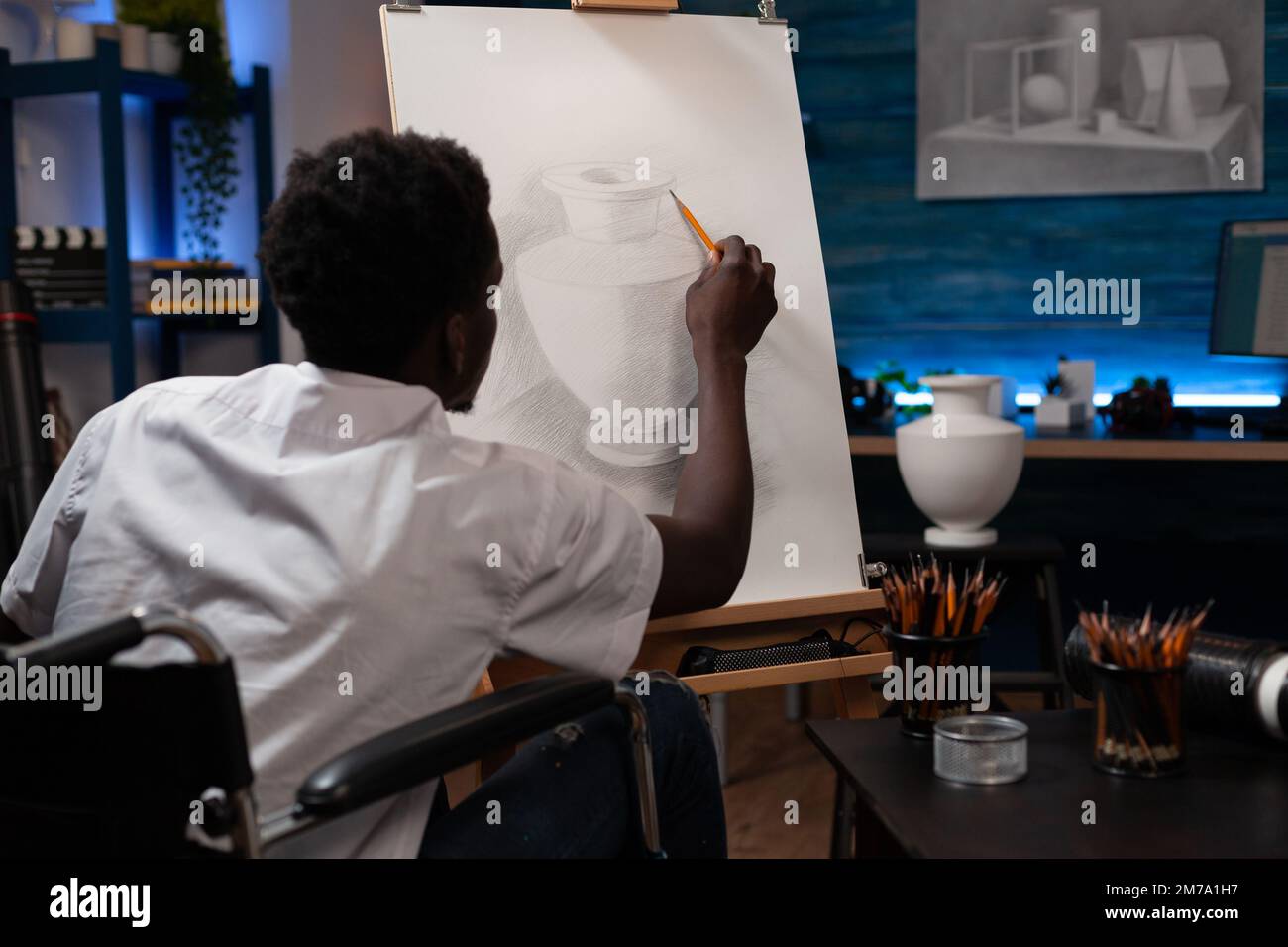 Male sketching artist living with walking disability creating pencil ...