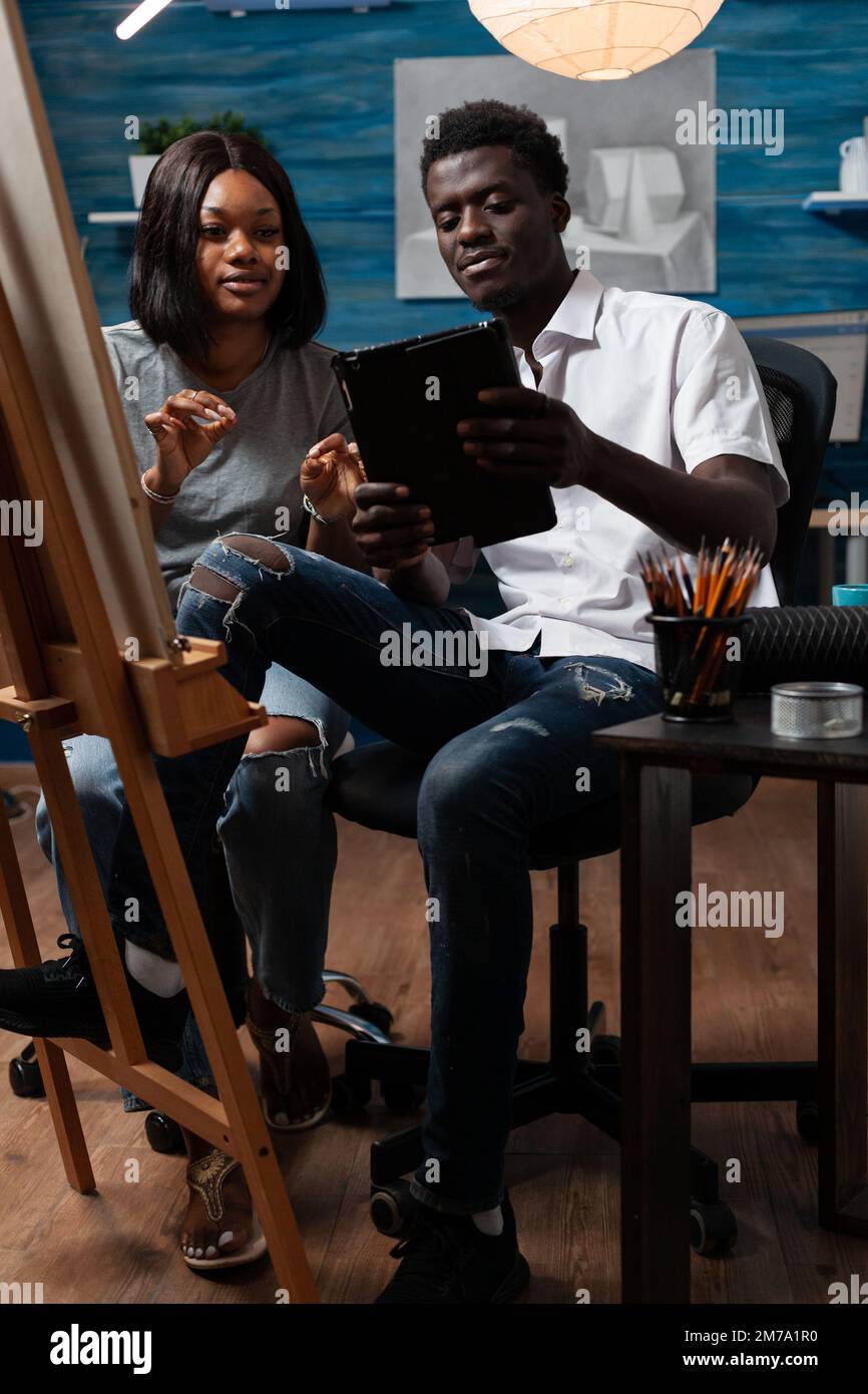 Art classmates doing drawing project at home with help of tablet ...