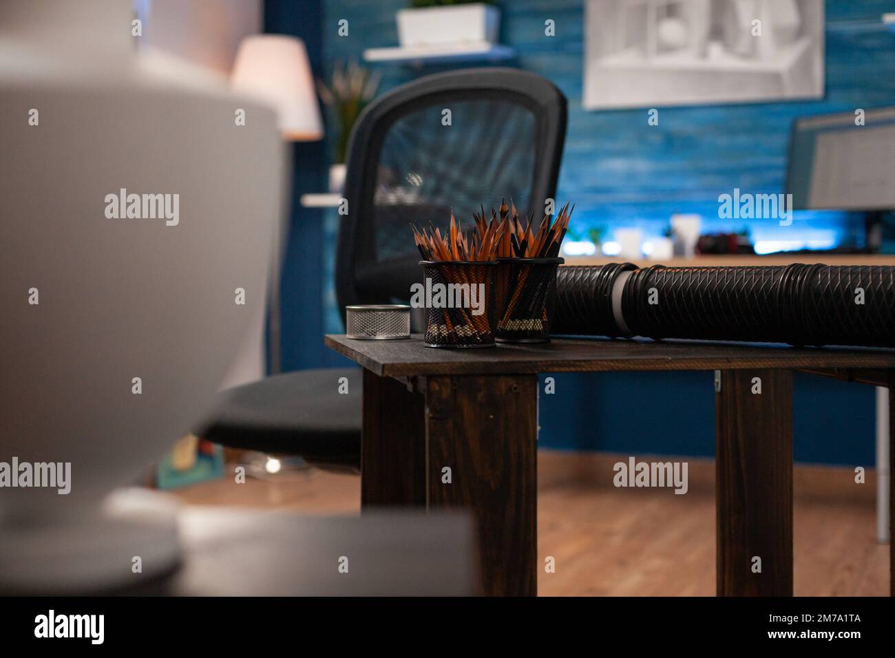 Close up of coloring pencils jars over desk with artistic supplies in ...