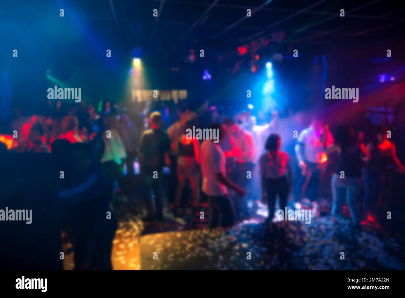 silhouettes of a crowd of people dancing in a nightclub on the dance ...