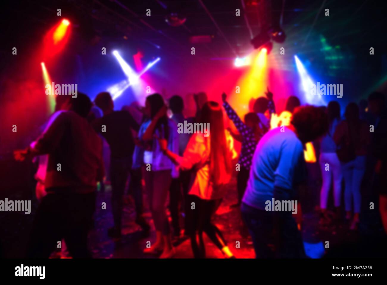 Crowd dancing under colorful spotlights hi-res stock photography and ...