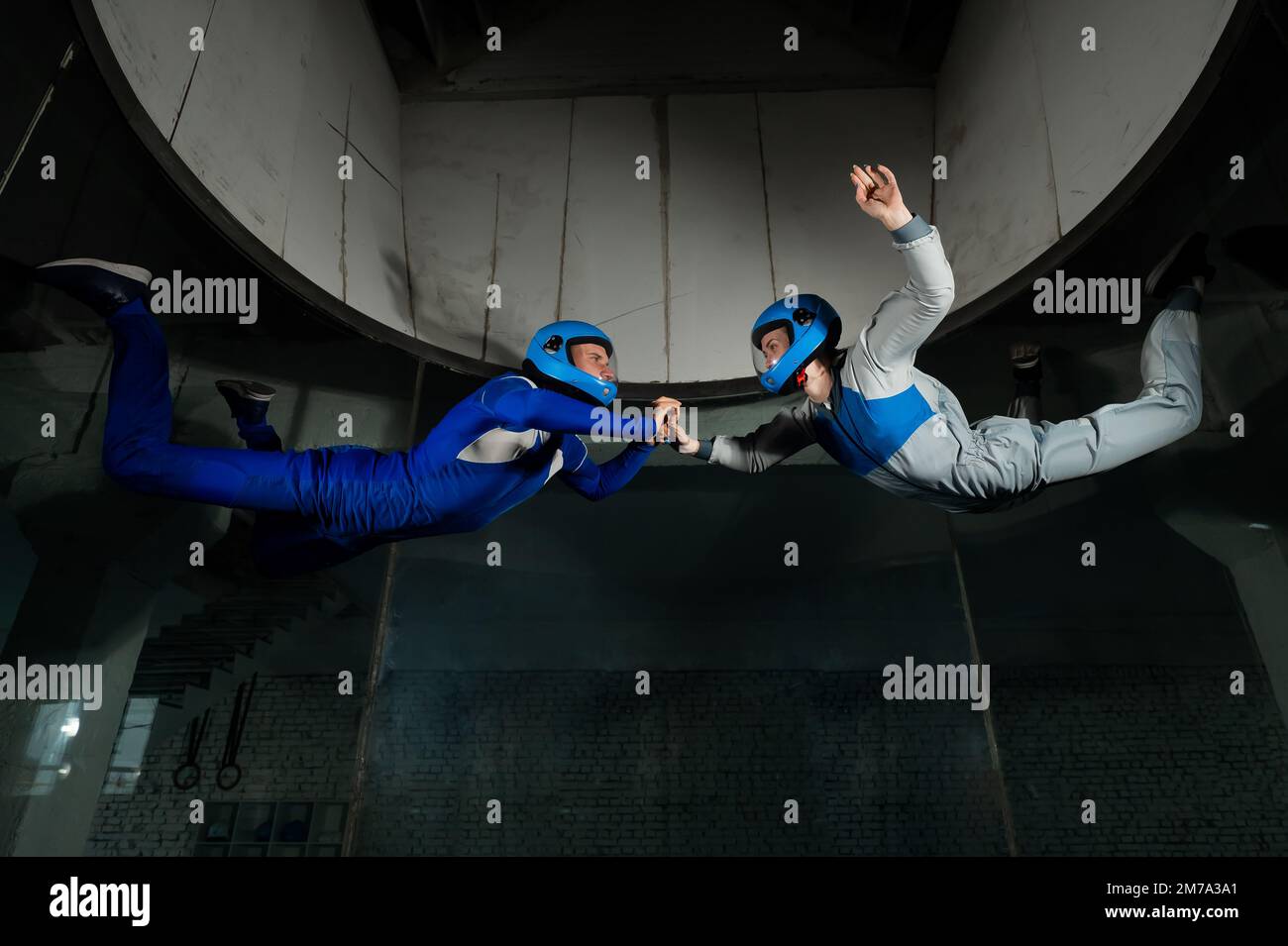 A man and a woman enjoy flying together in a wind tunnel. Free fall ...