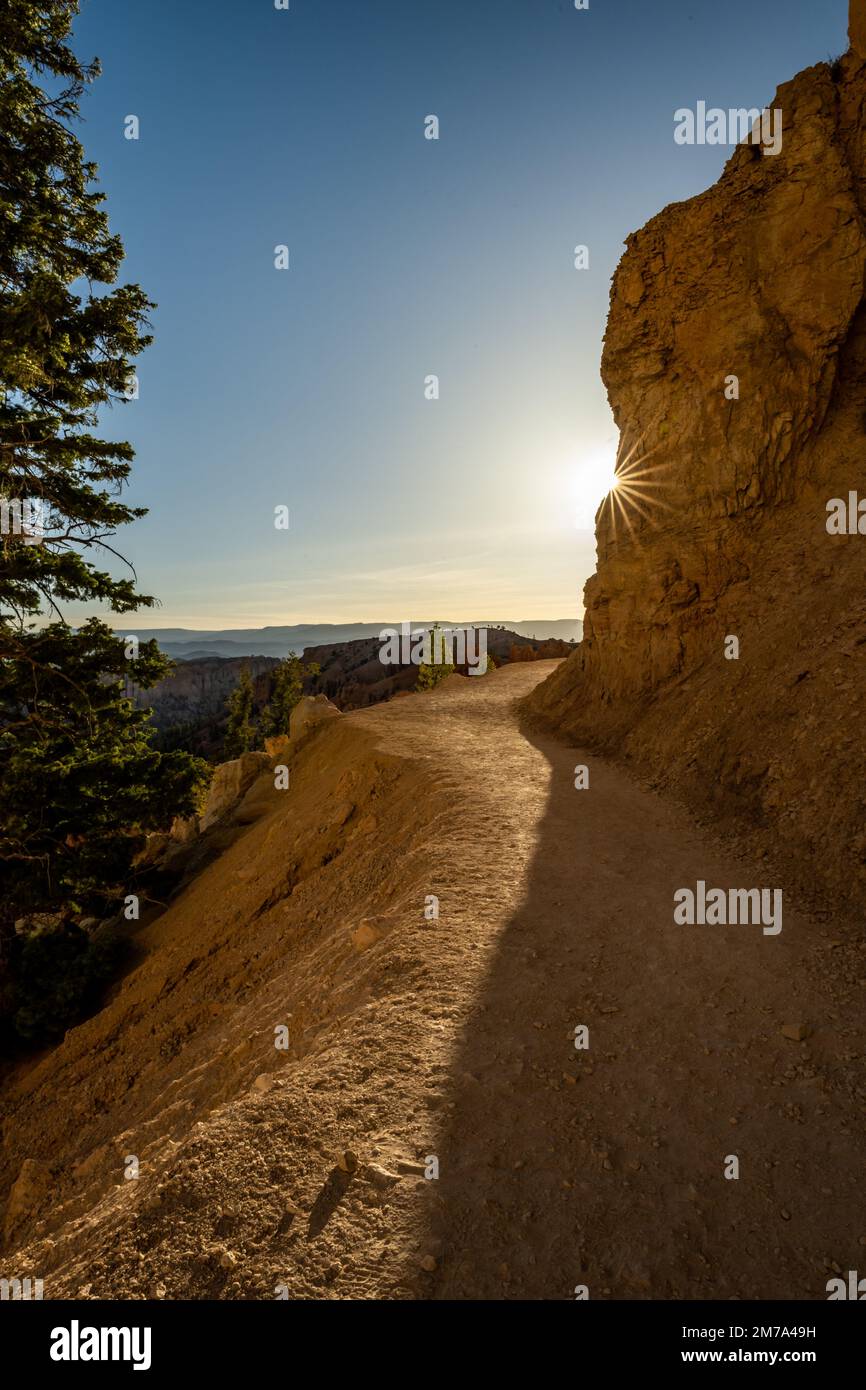 Sun Burst Flares Along the Cliff Wall Next to Trail in Bryce Canyon ...