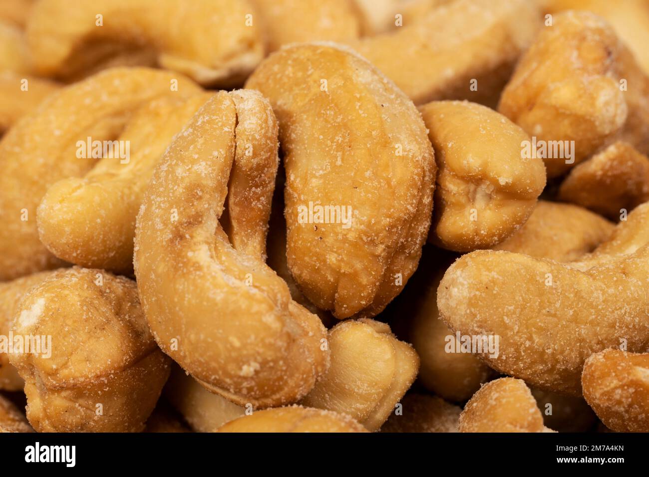 A pile of roasted and salted cashews isolated Stock Photo - Alamy