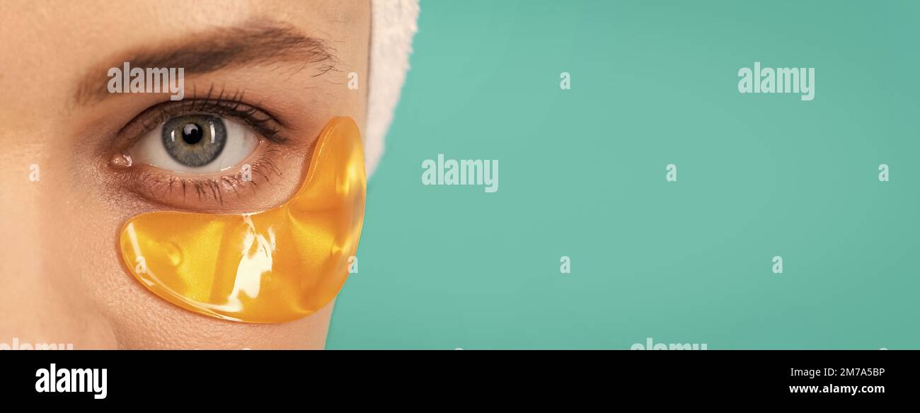 closeup of young lady has collagen golden eye patches on face with ...