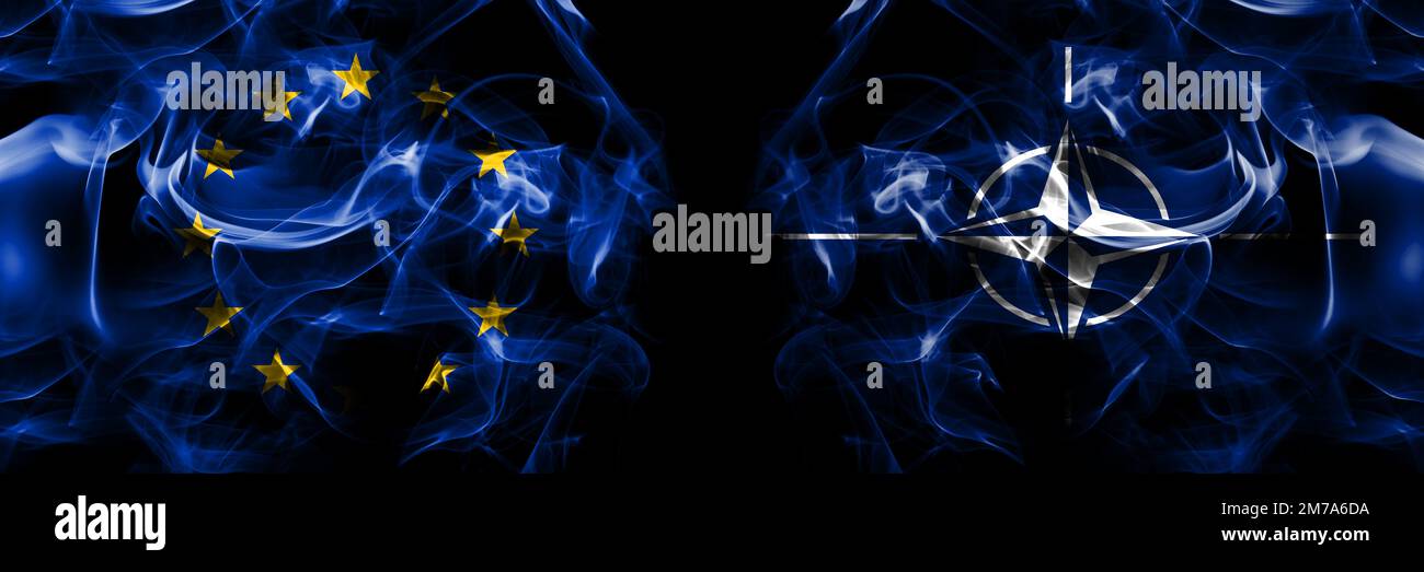 Flags of EU, European Union vs Organizations, NATO. Smoke flag placed ...