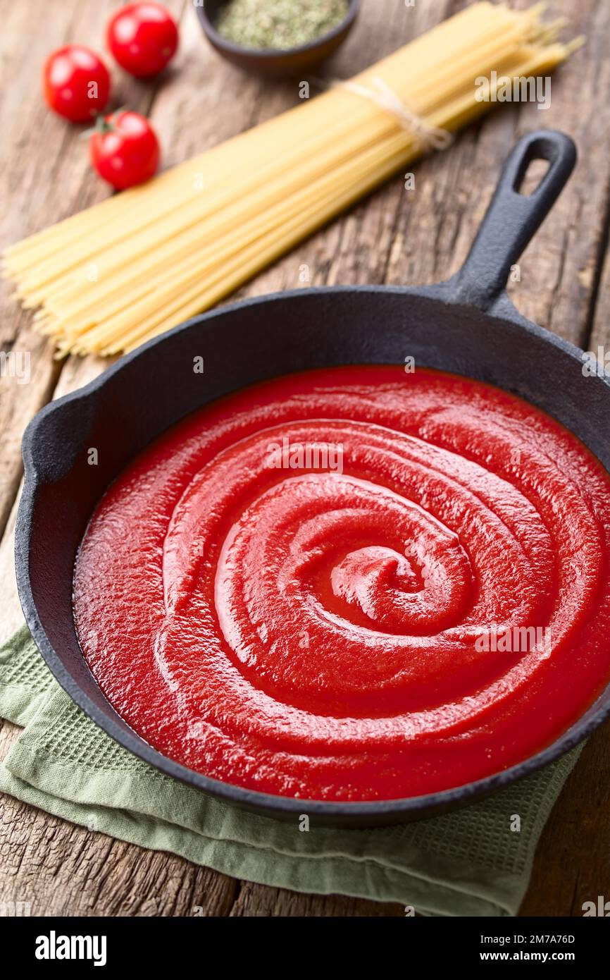 Tomato paste in cast iron skillet, with dry spaghetti, cherry tomato ...