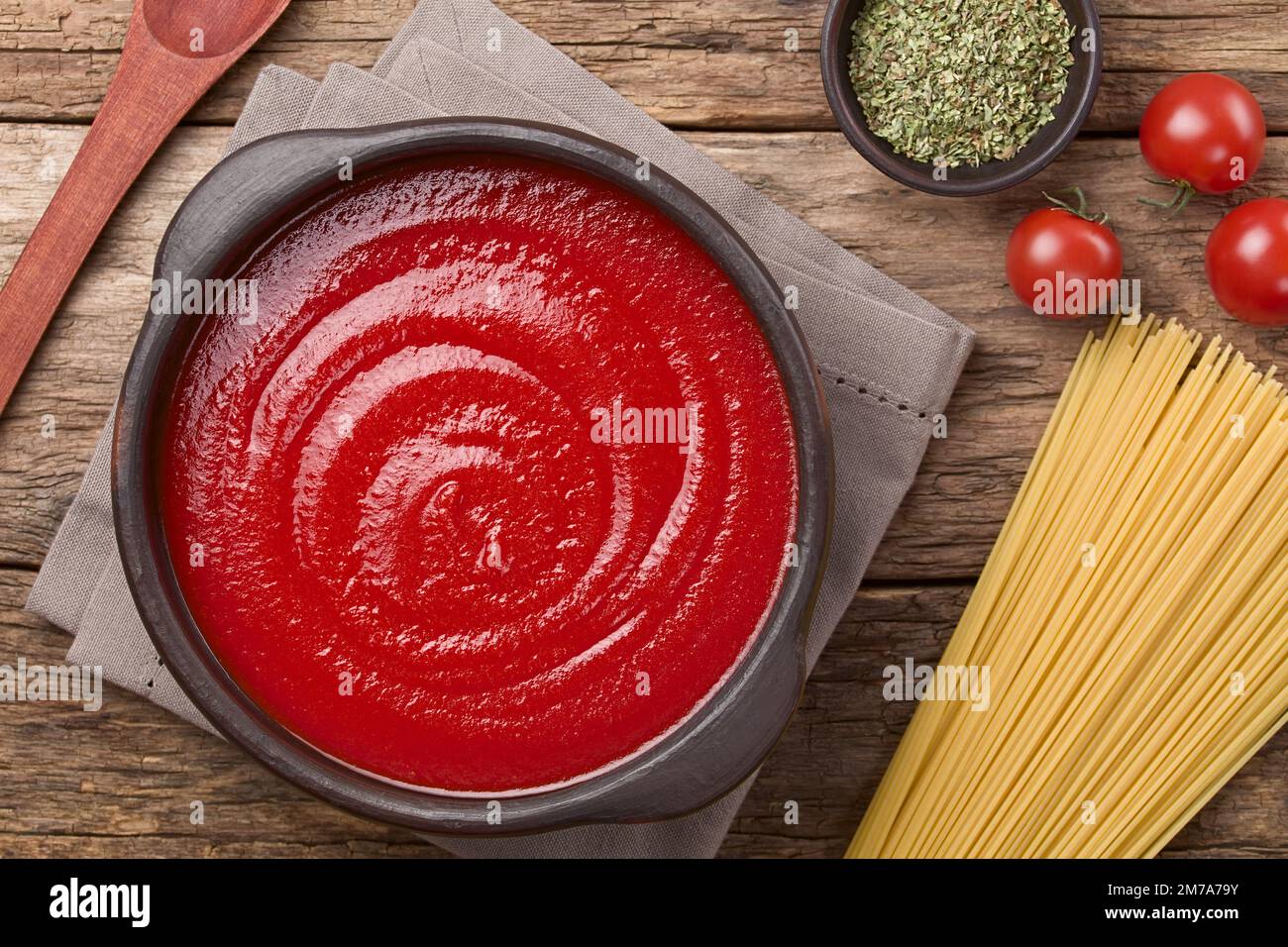 Tomato paste in rustic bowl, with dry spaghetti, cherry tomato, dried ...