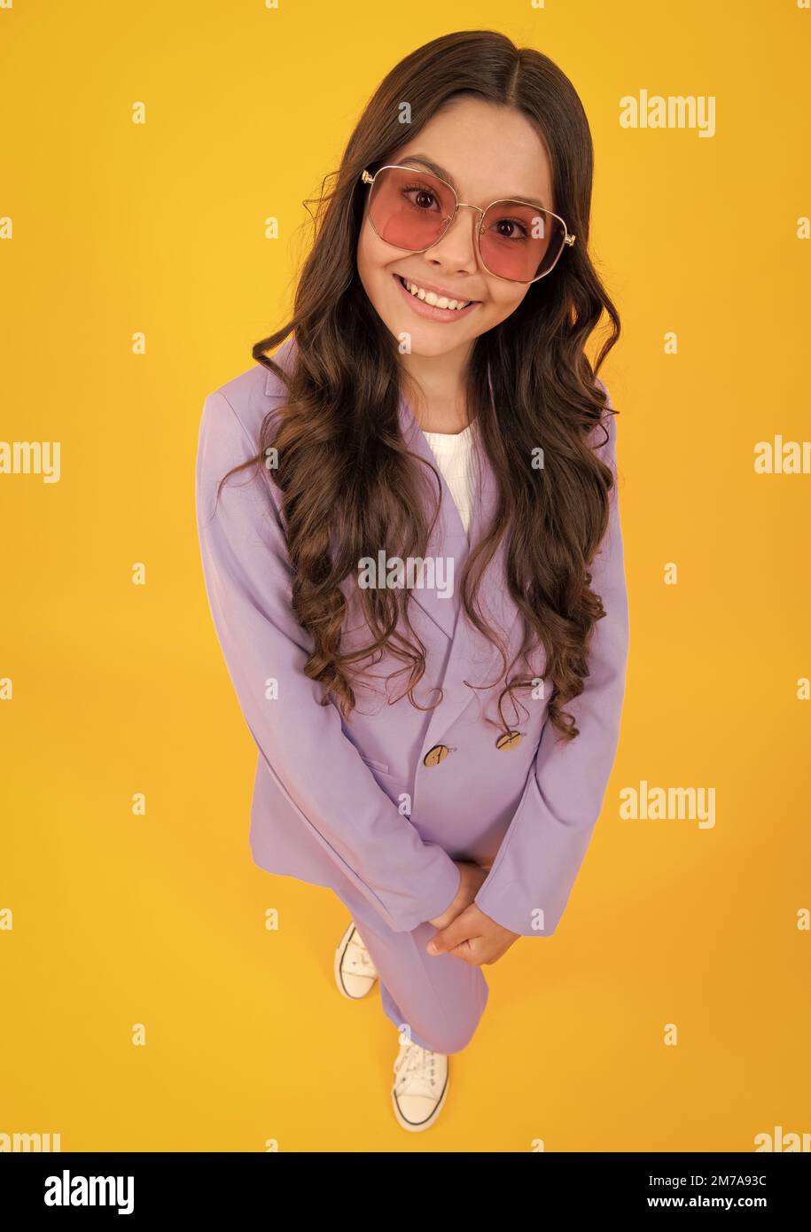 Elegant fashion teenager child girl posing in studio. Trends kids ...