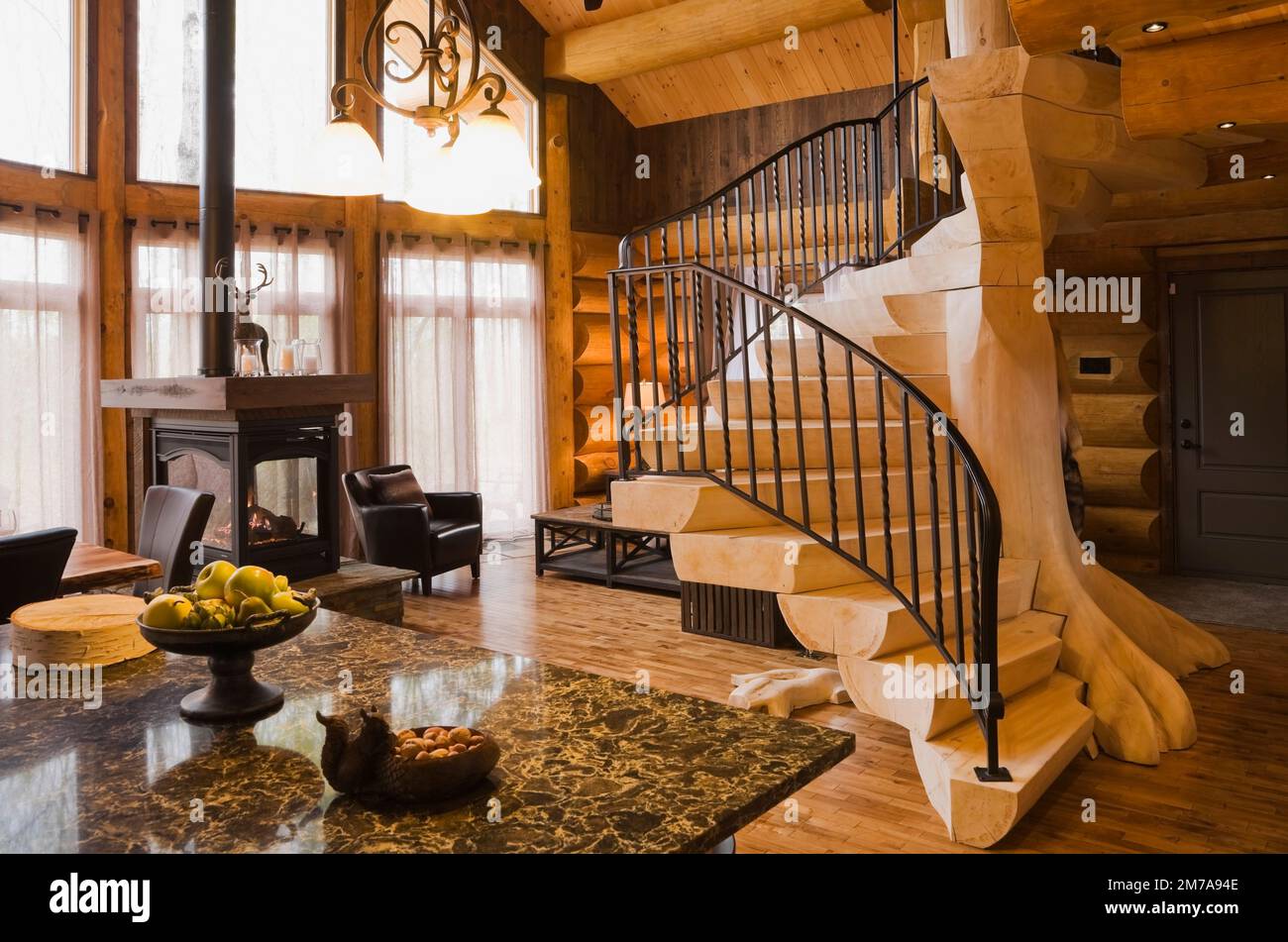 Quartz island countertop, propane gas fireplace and bleached wooden ...