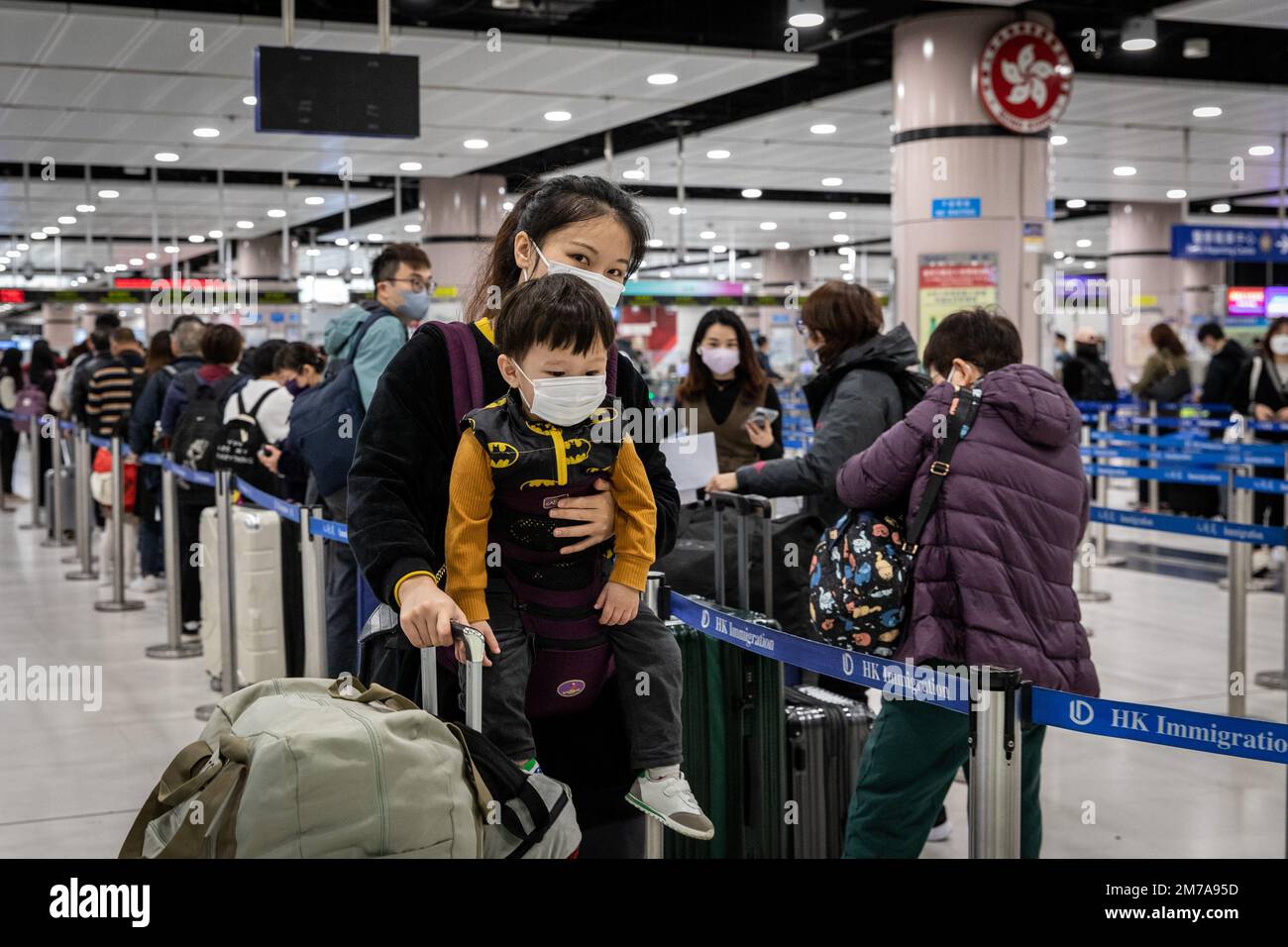 A mother and her son walked up to the queue at the border control ...