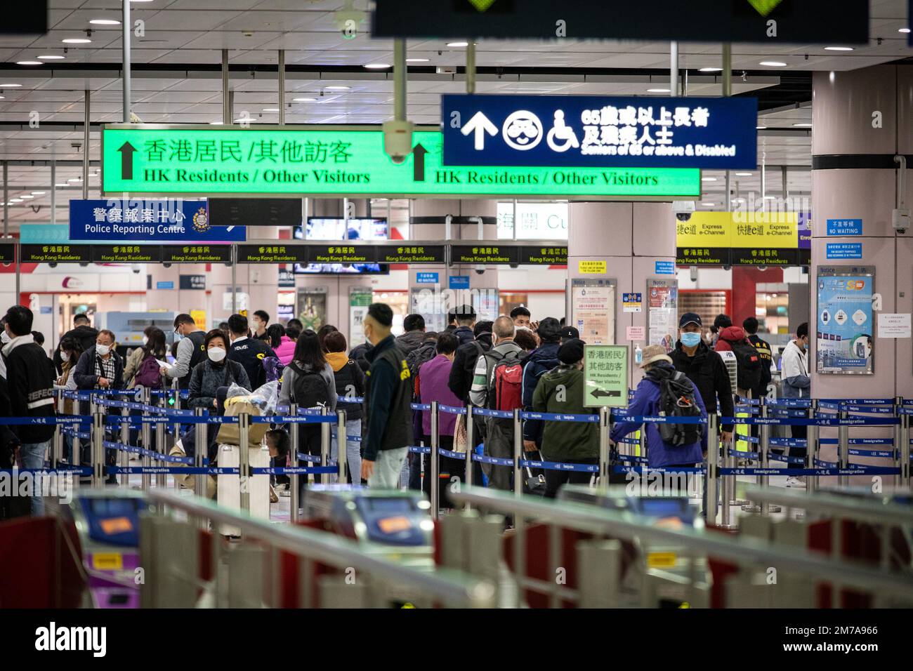 People line up at the border control area as they departs to Shenzhen ...