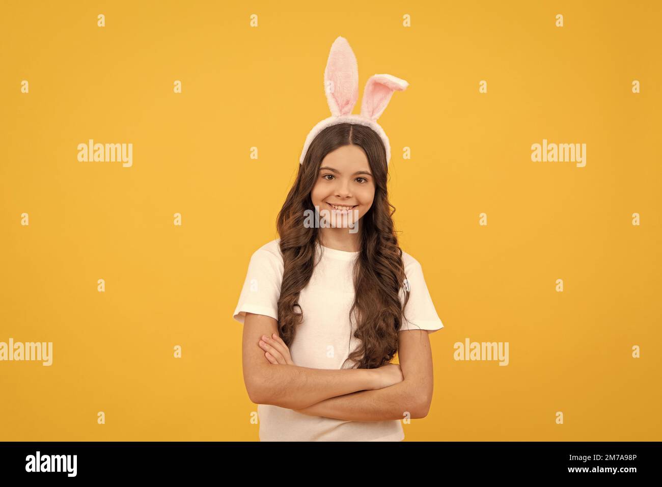cheerful child in bunny ears on yellow background, easter Stock Photo ...