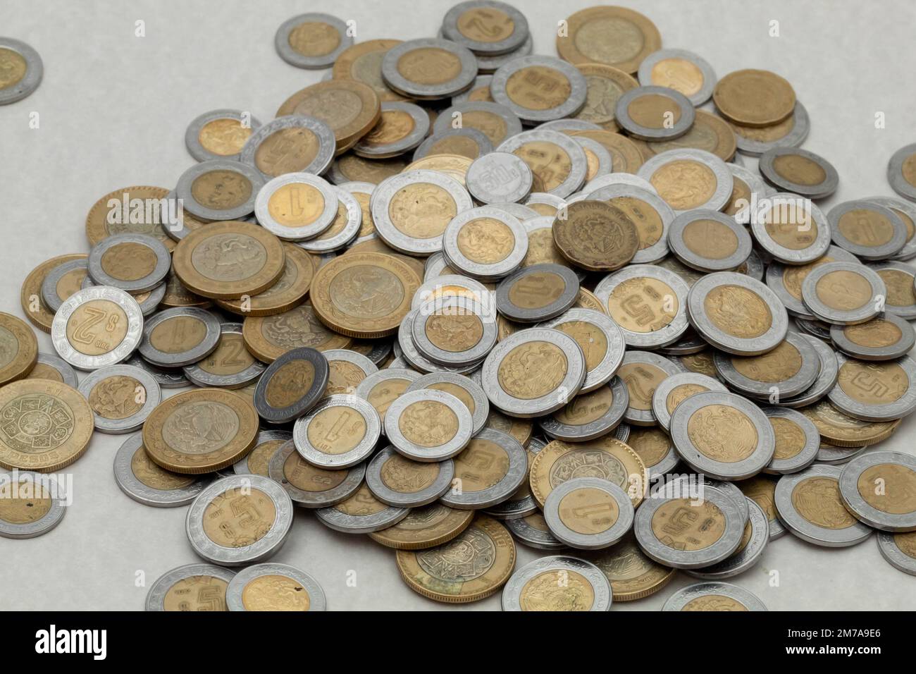 bunch of Mexican pesos coins of various denominations, with copy space ...