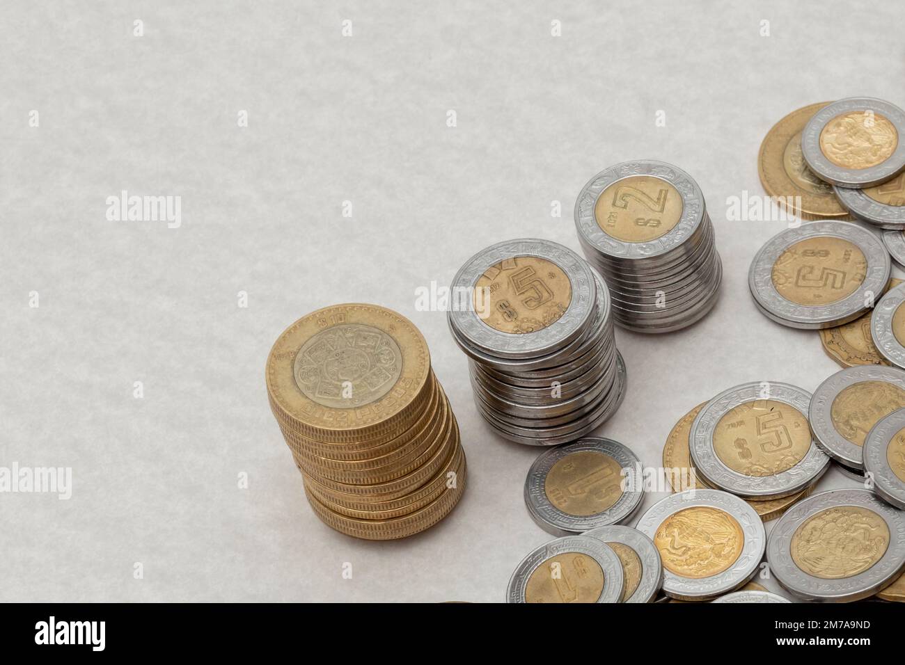 stack of mexican peso coins of various denominations, with copy space ...