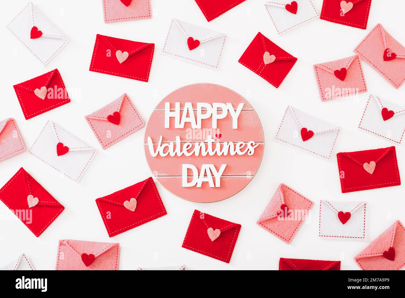 Happy Valentine's Day message and many felt envelopes with hearts on ...