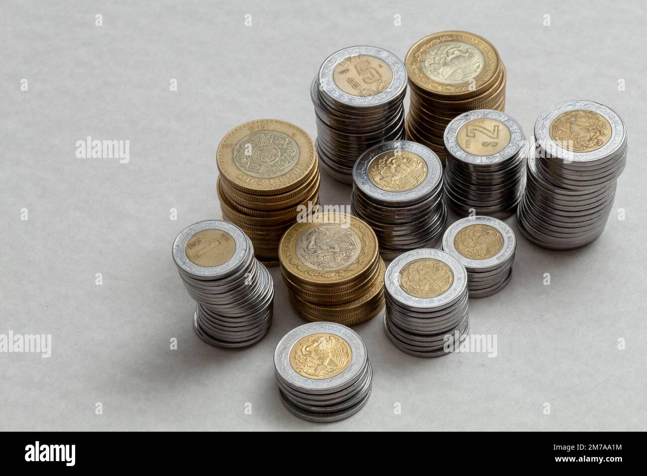 Mexican pesos coins stacked by denominations , on a table Stock Photo ...