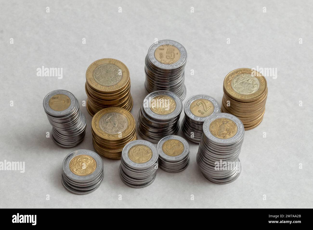 Mexican pesos coins stacked by denominations , on a table Stock Photo ...