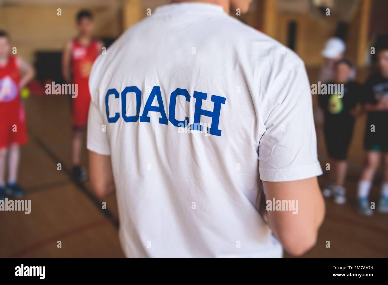 Junior young basketball team with a coach, group of kids children team ...