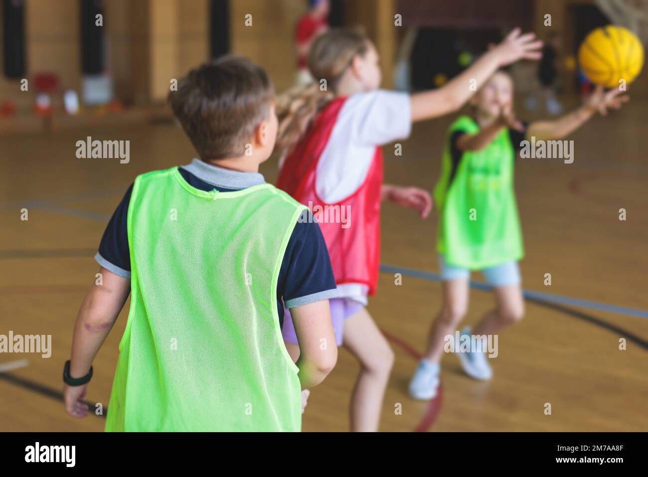 Junior teenage school team of kids children play basketball, players in ...