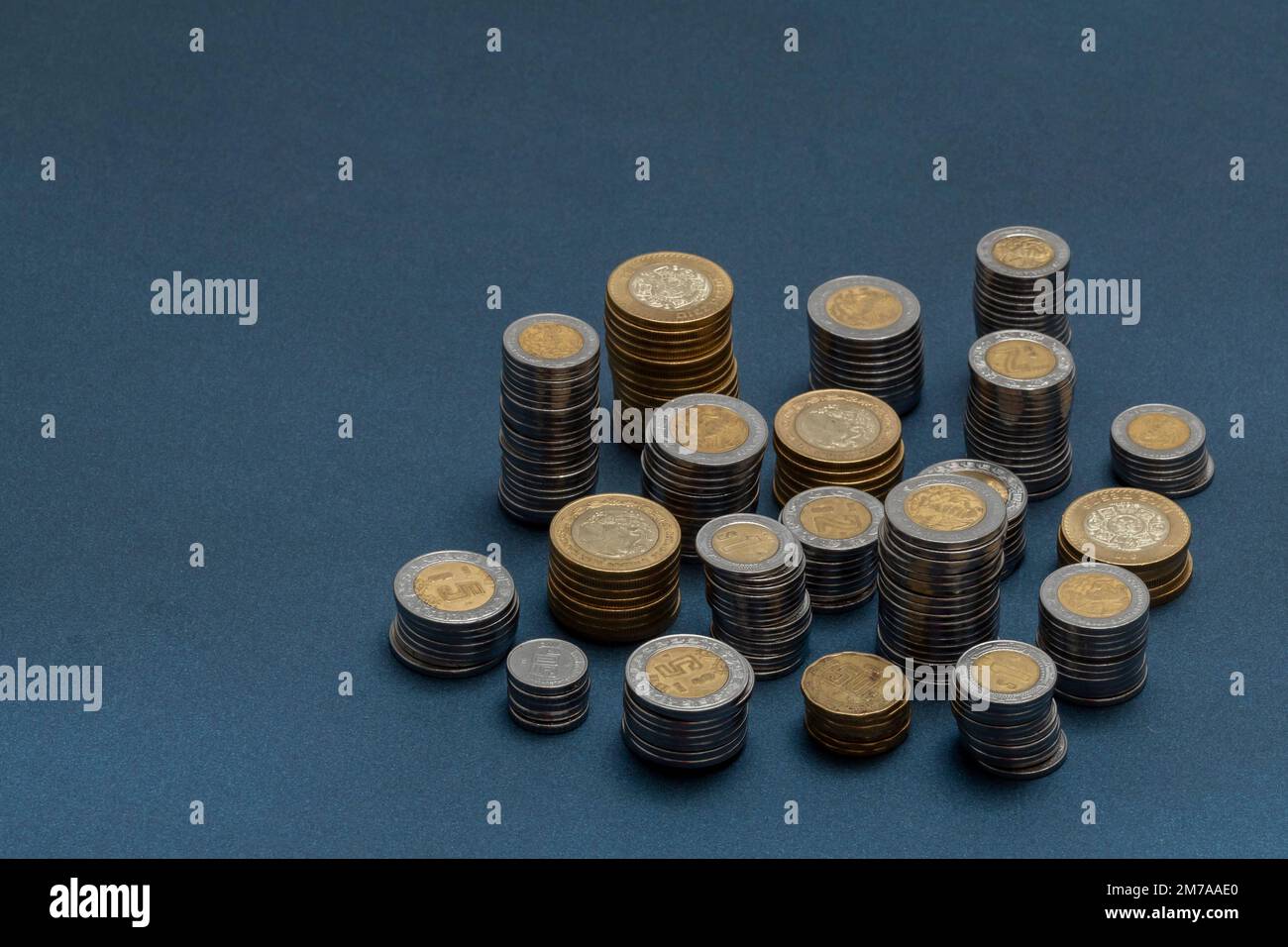 Piles of Mexican pesos coins, of different denominations isolated with ...