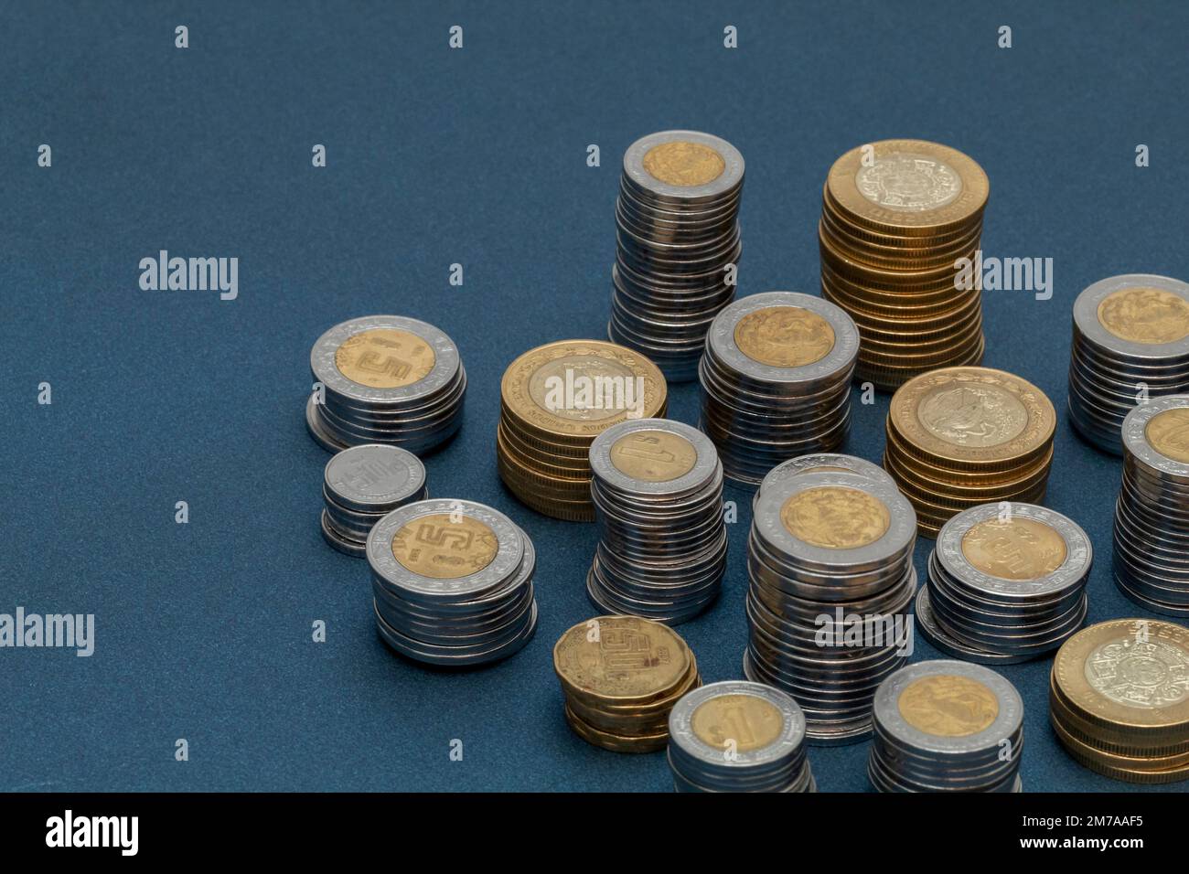 Piles of Mexican pesos coins, of different denominations isolated with ...