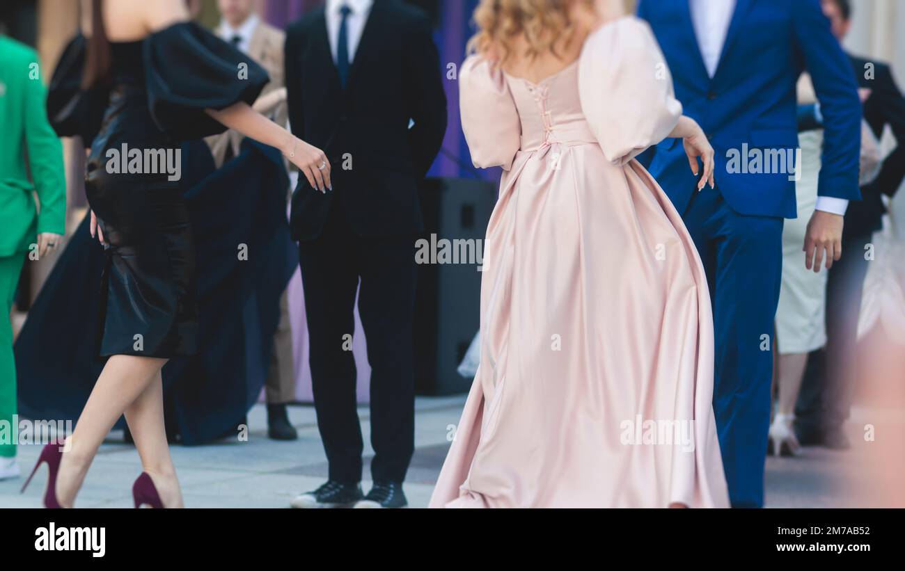 High school graduates dancing waltz and classical ball dance in dresses ...