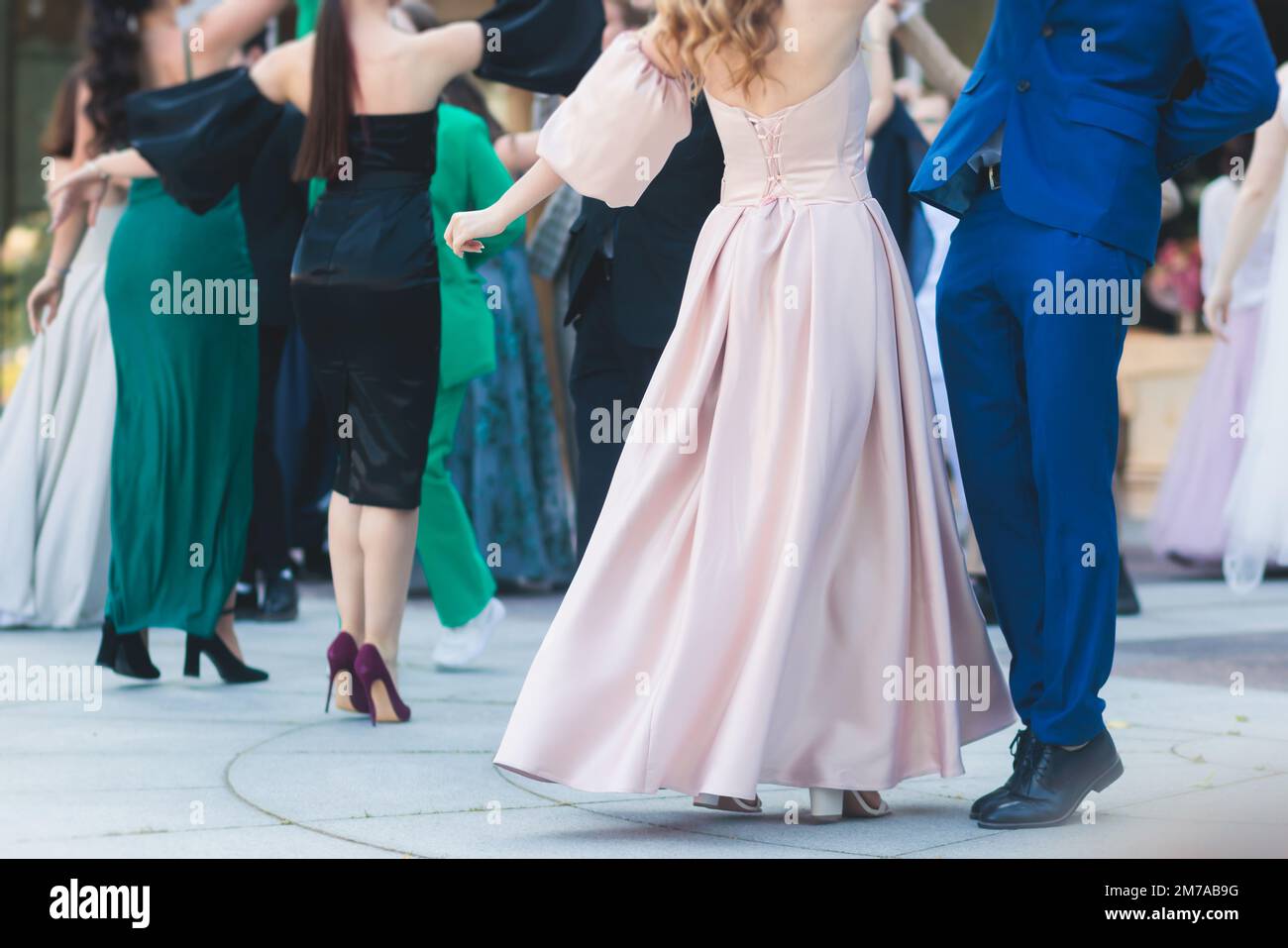 High school graduates dancing waltz and classical ball dance in dresses ...