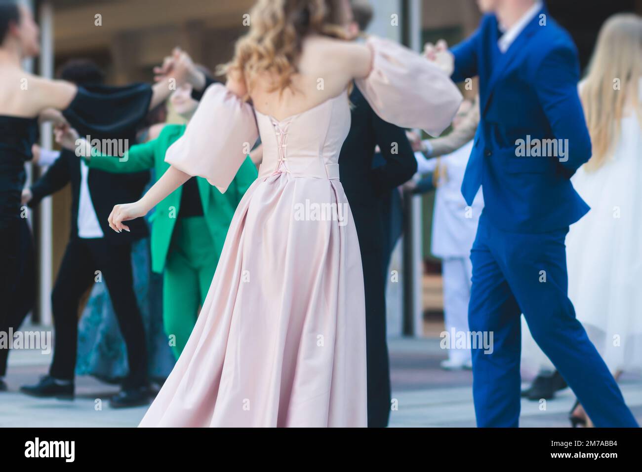 High school graduates dancing waltz and classical ball dance in dresses ...