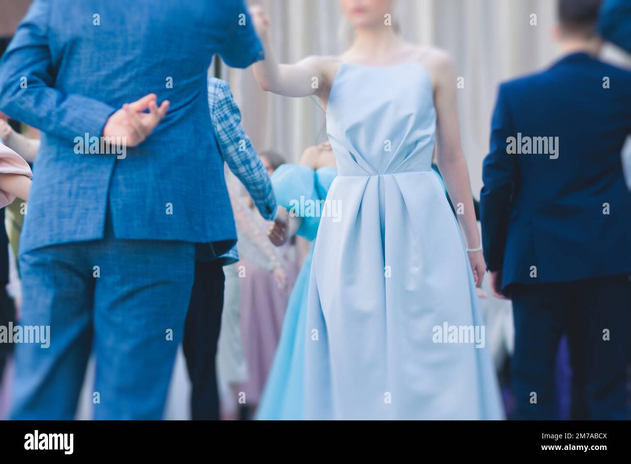 High school graduates dancing waltz and classical ball dance in dresses ...