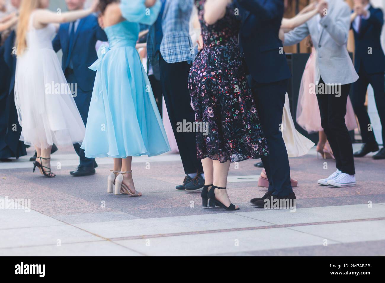High school graduates dancing waltz and classical ball dance in dresses ...