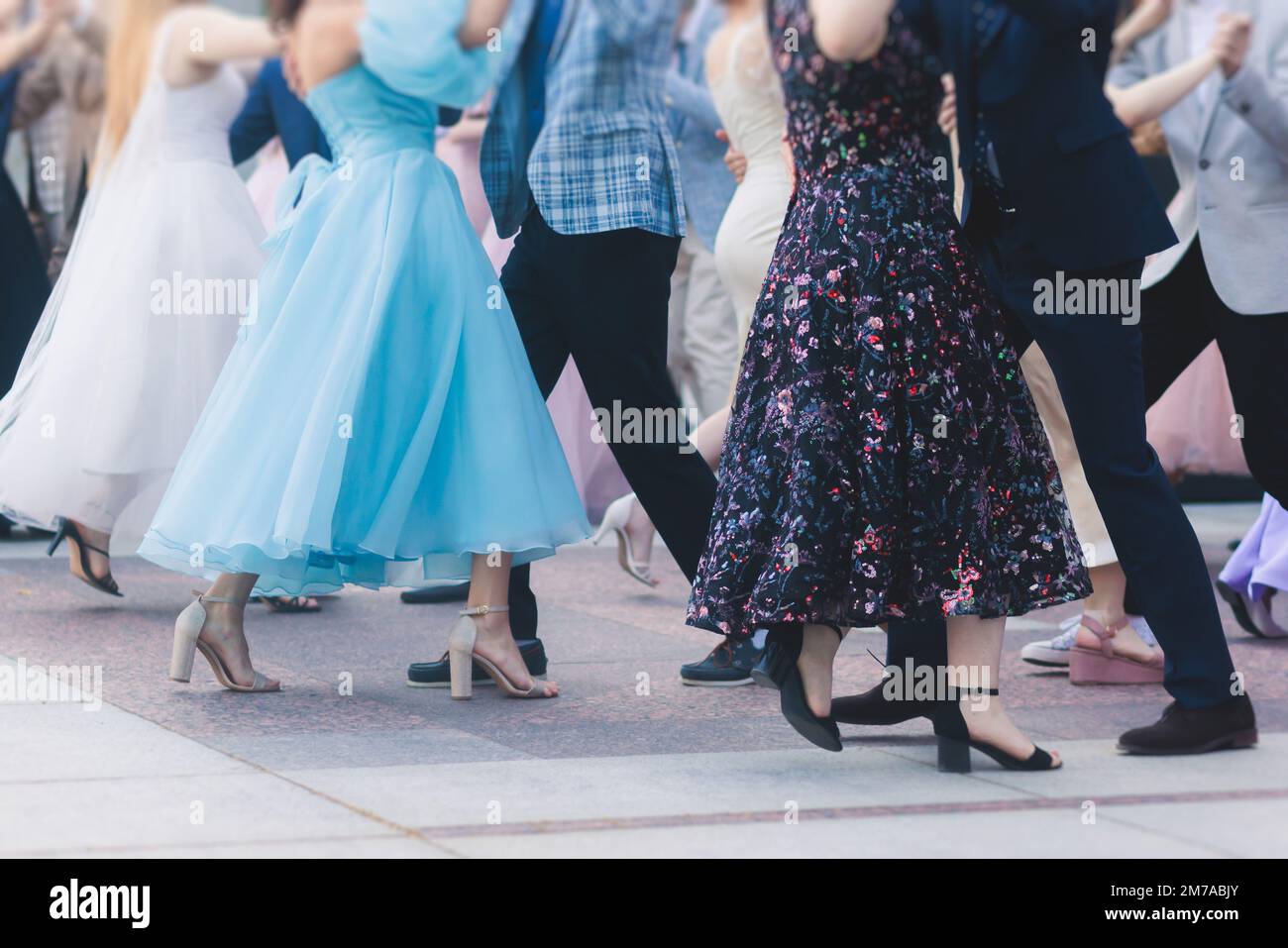 High school graduates dancing waltz and classical ball dance in dresses ...