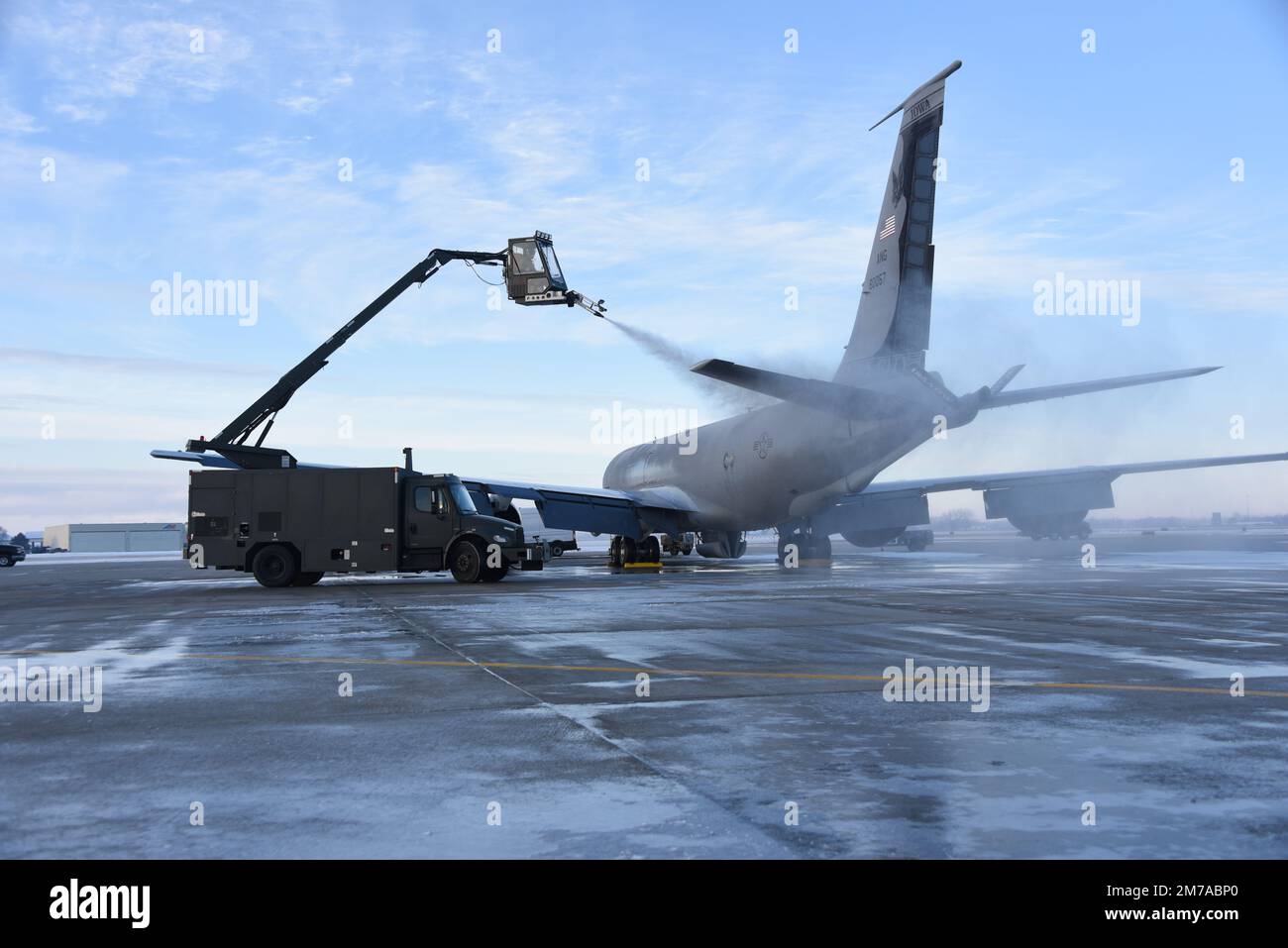 Crew chiefs from the Iowa Air National Guard use hot air to deice a U.S ...