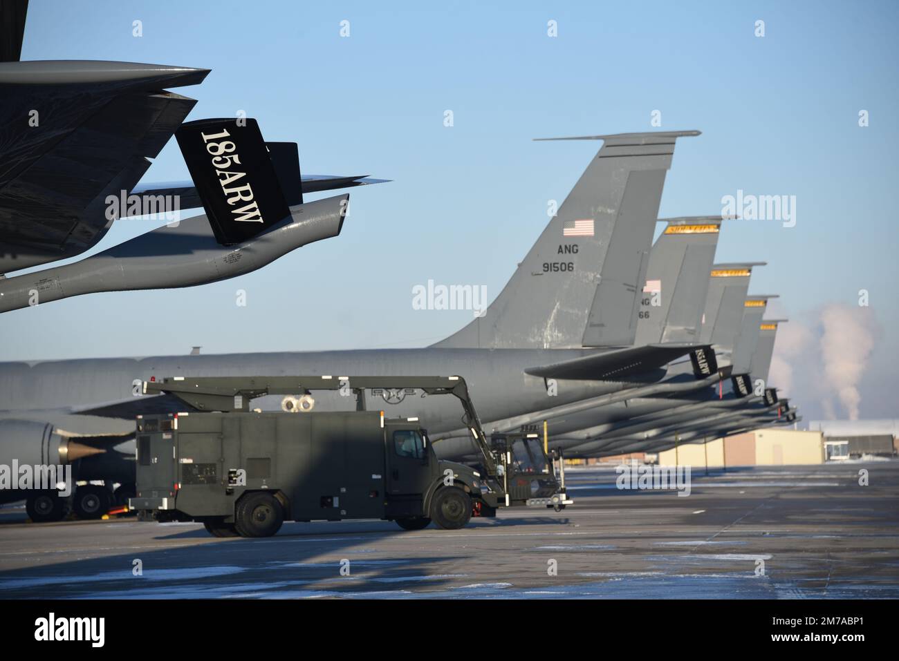 A deice truck passes through the shadow of a U.S. Air Force KC-135 ...