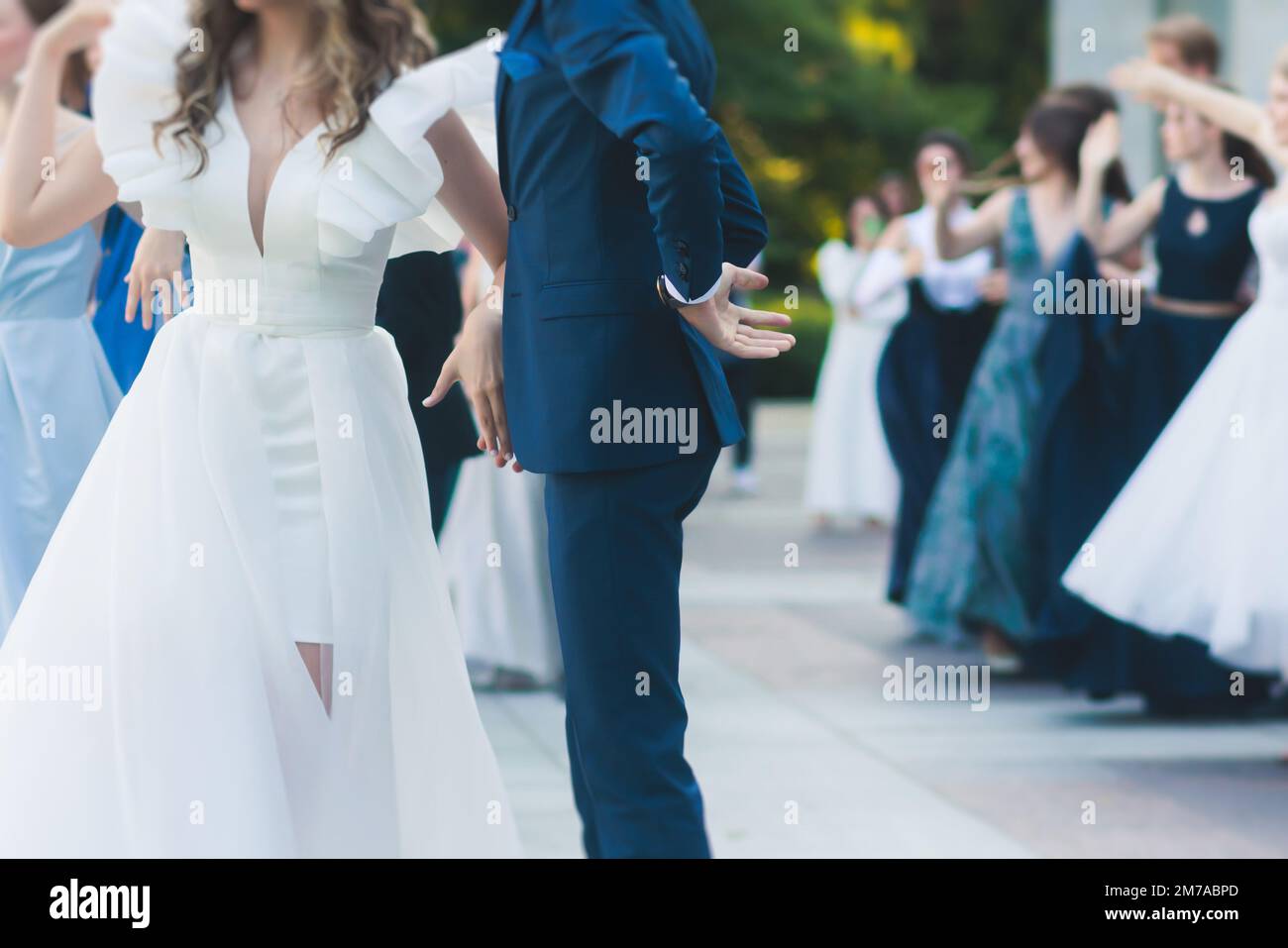 High school graduates dancing waltz and classical ball dance in dresses ...