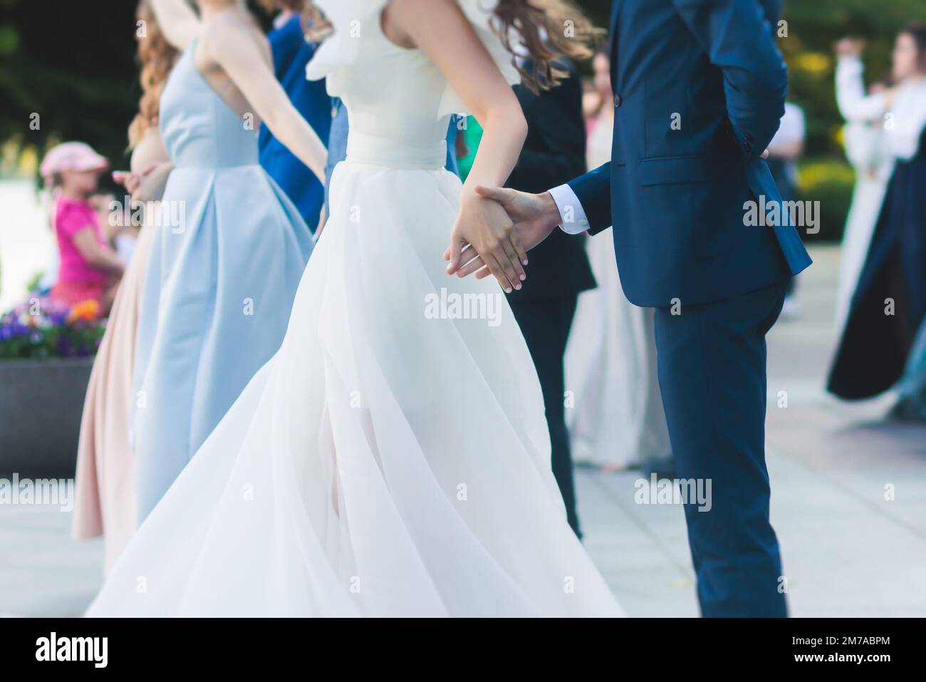 High school graduates dancing waltz and classical ball dance in dresses ...