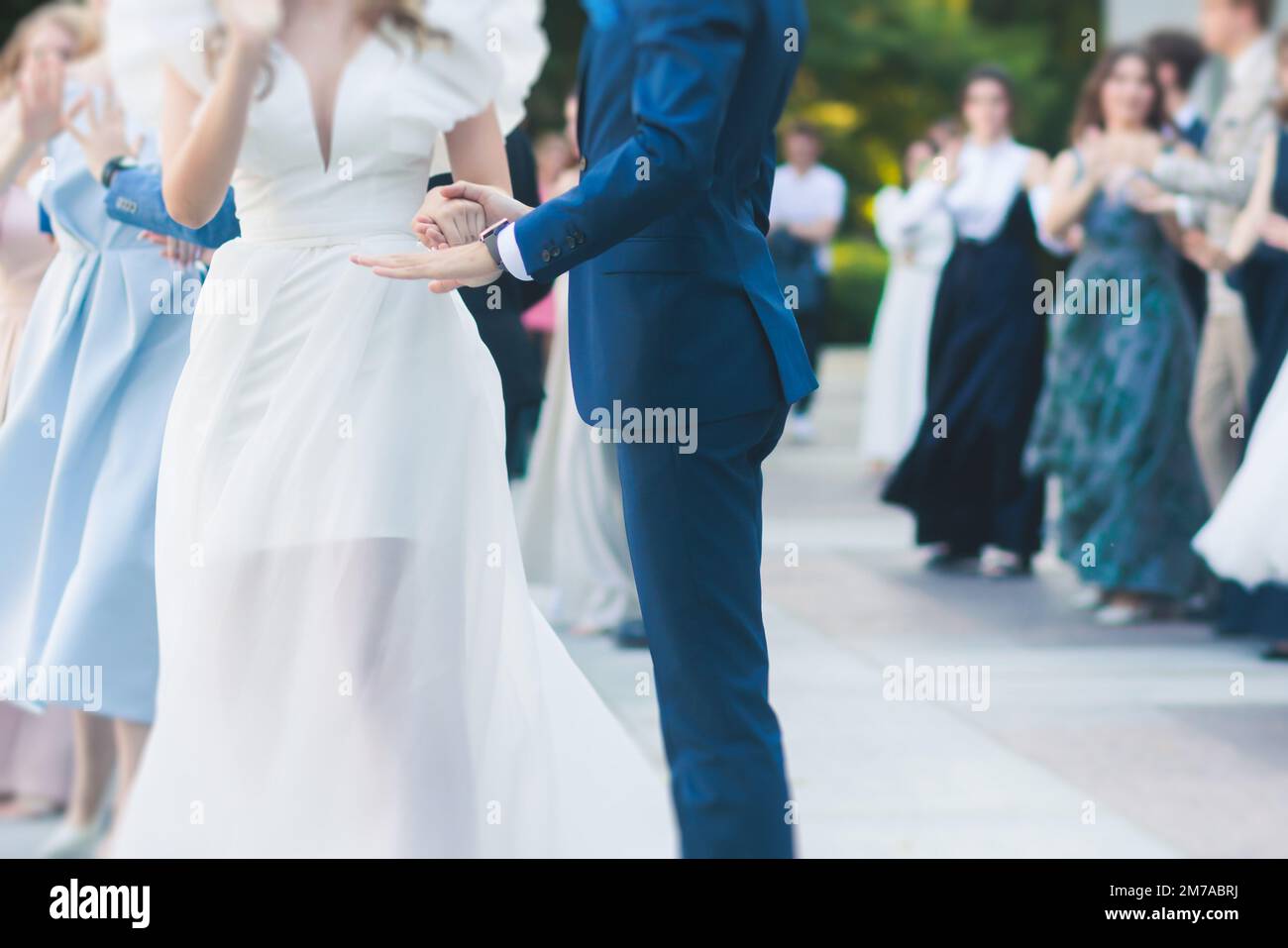 High school graduates dancing waltz and classical ball dance in dresses ...