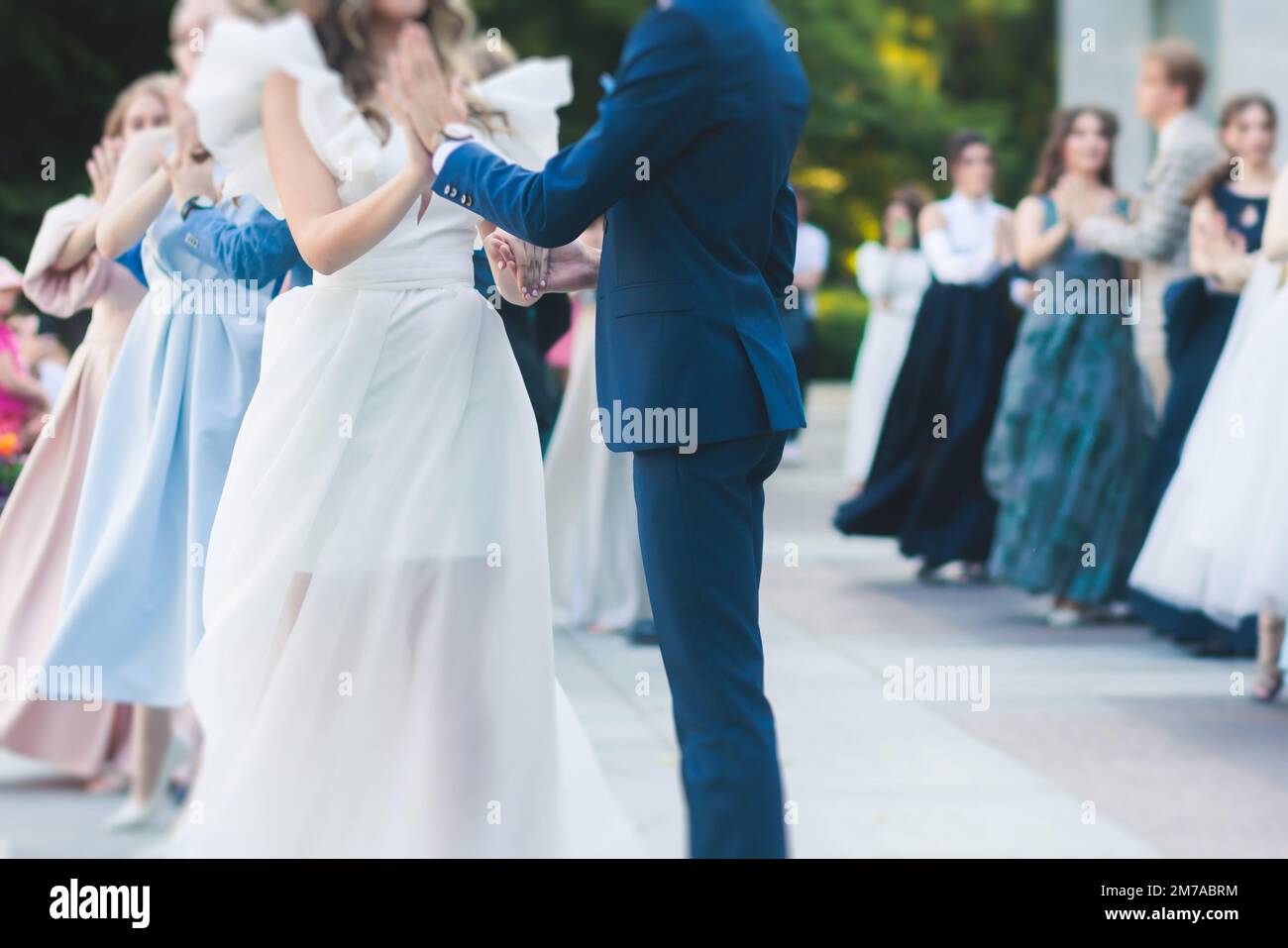 High school graduates dancing waltz and classical ball dance in dresses ...