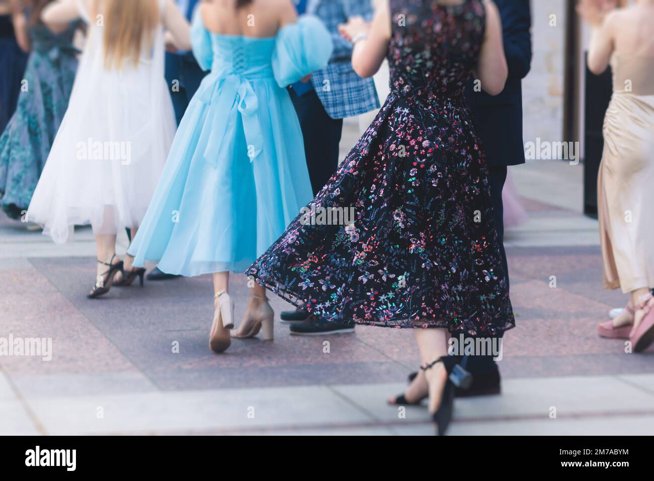 High school graduates dancing waltz and classical ball dance in dresses ...