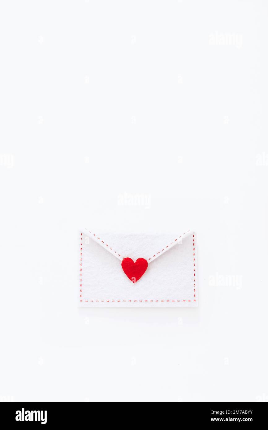 Felt envelope with red heart on white background Stock Photo - Alamy