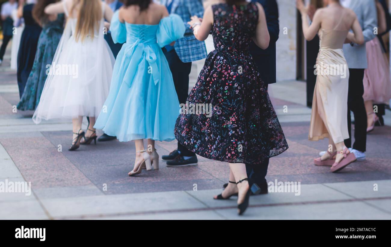 High school graduates dancing waltz and classical ball dance in dresses ...