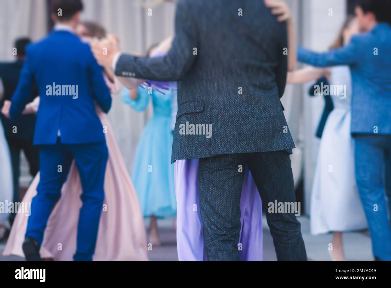 High school graduates dancing waltz and classical ball dance in dresses ...
