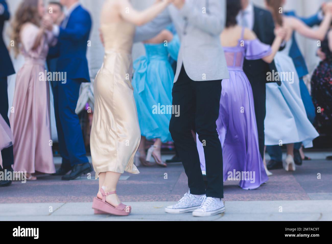 High school graduates dancing waltz and classical ball dance in dresses ...