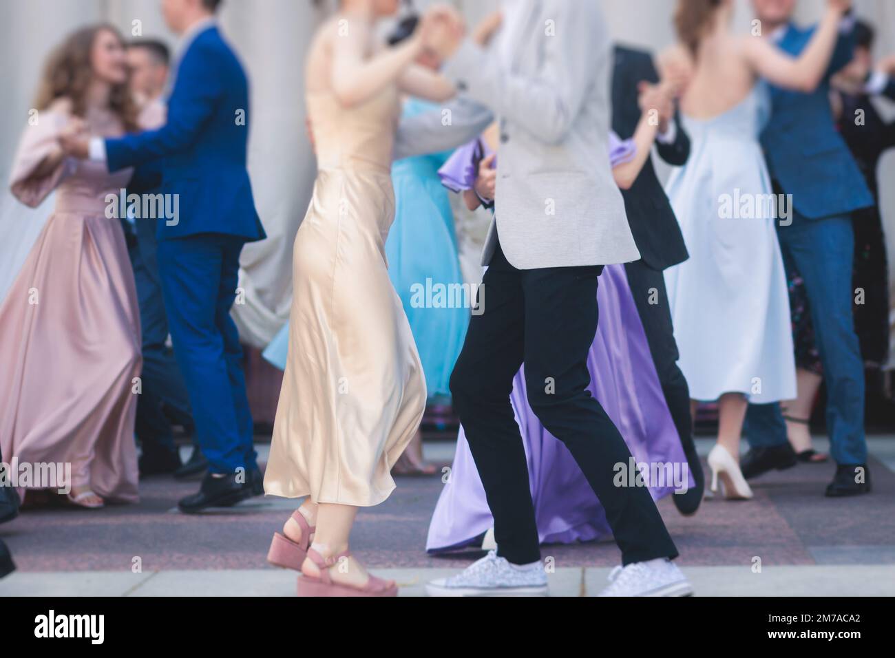 High school graduates dancing waltz and classical ball dance in dresses ...