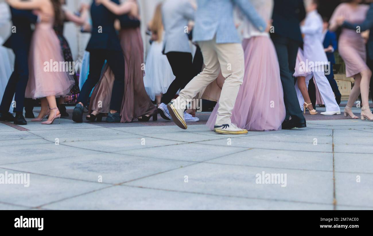High school graduates dancing waltz and classical ball dance in dresses ...