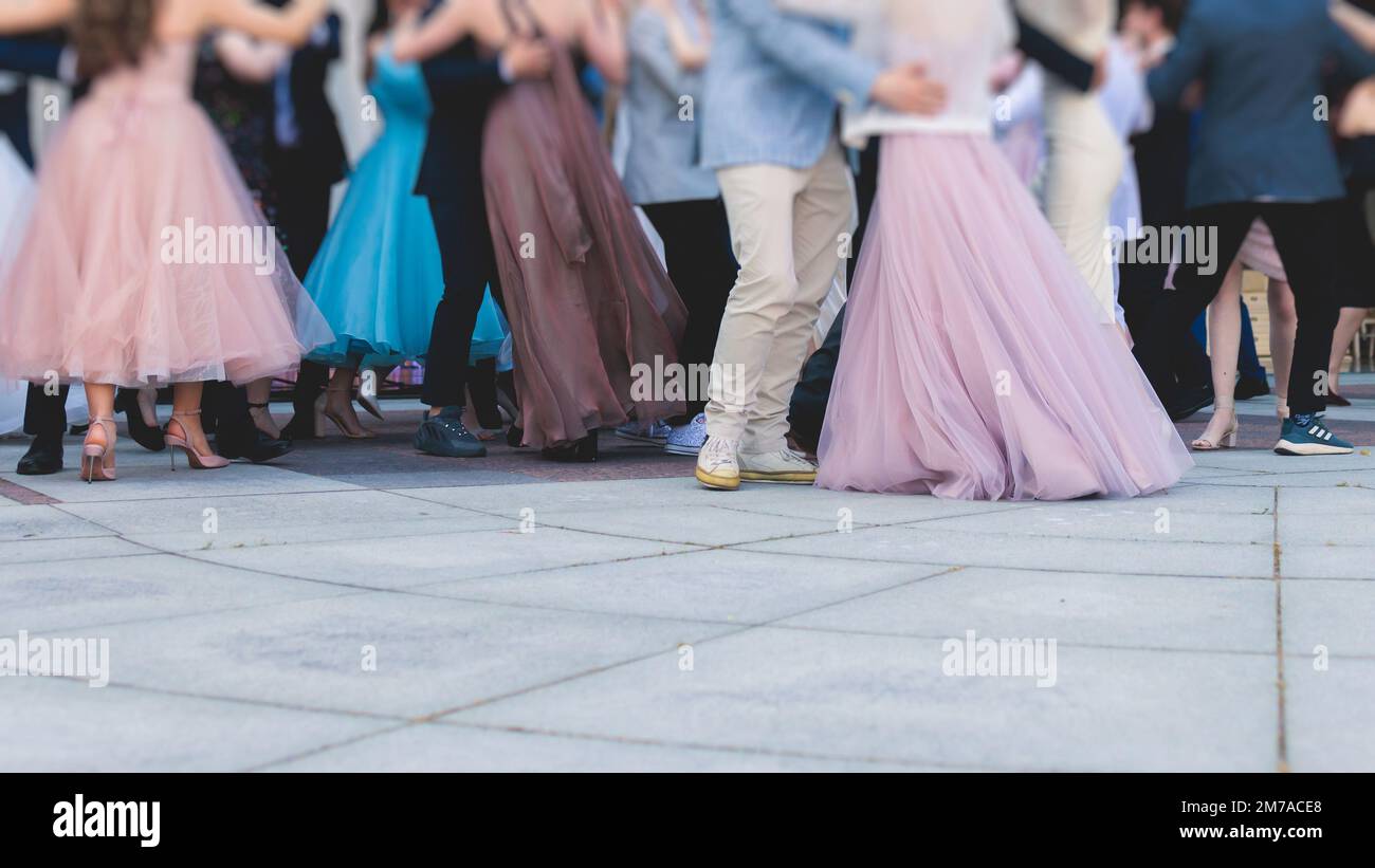 High school graduates dancing waltz and classical ball dance in dresses ...