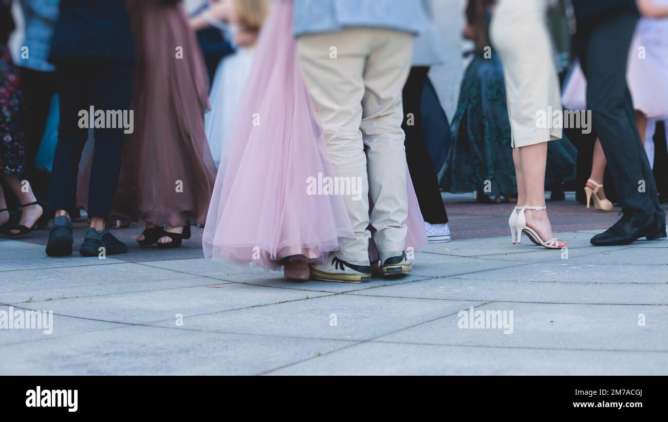 High school graduates dancing waltz and classical ball dance in dresses ...