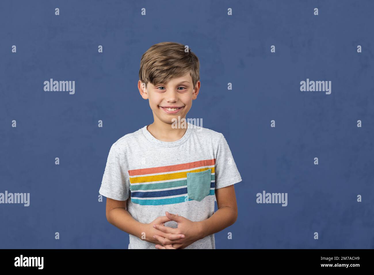 a cute autistic elementary school boy on a blue background with copy ...